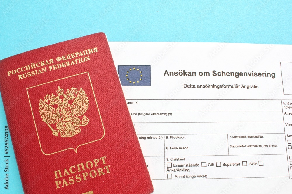 Schengen visa application form in Swedish language and passport on blue ...