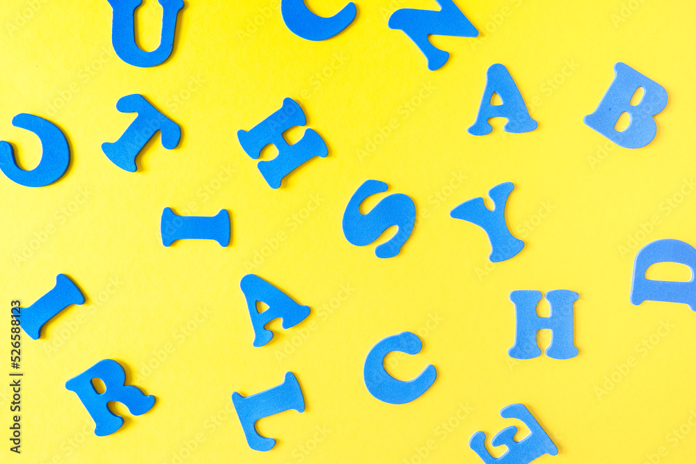 Colored letters of the alphabet on a yellow background. Educational ...