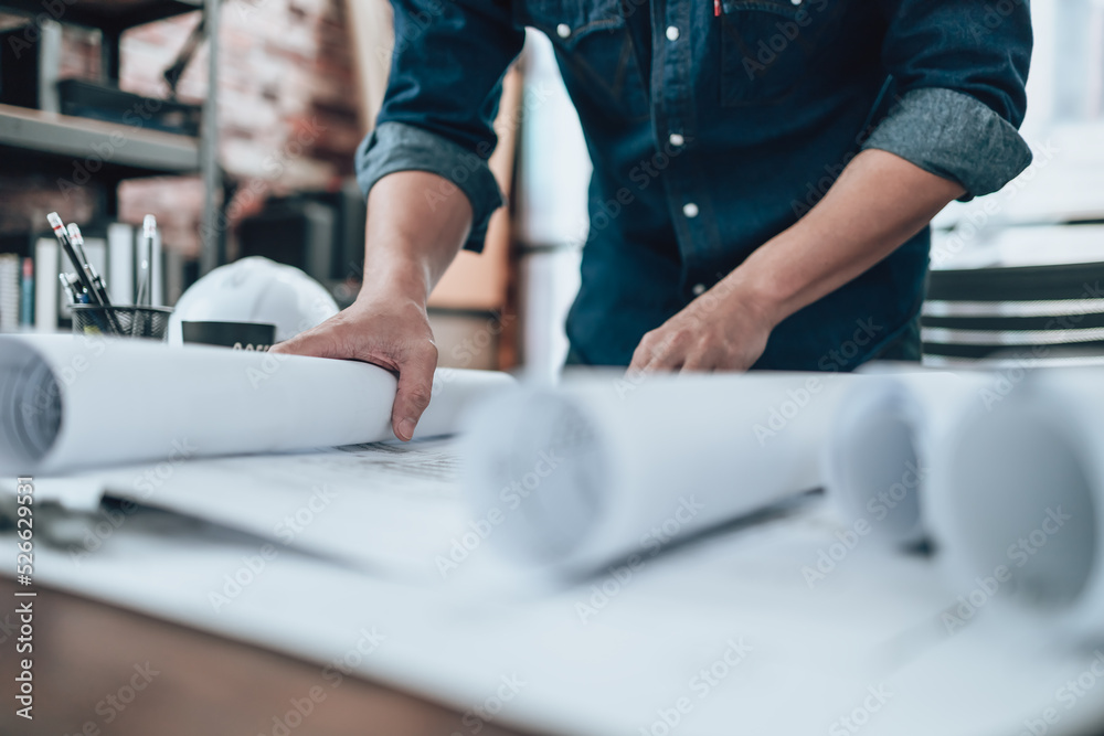Engineering working with drawings inspection on the office desk and ...