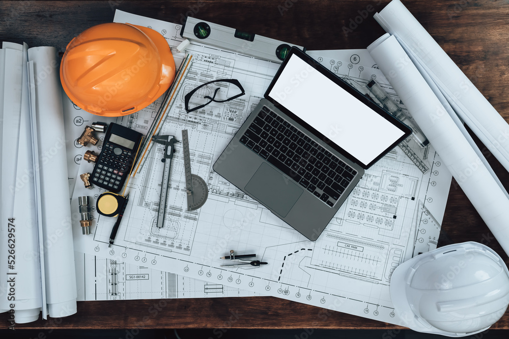 Laptop with drawings inspection on the office desk and Calculator ...