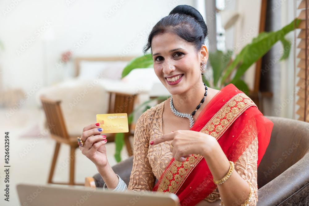Beautiful smiling Indian or Nepali woman in traditional costume holding ...