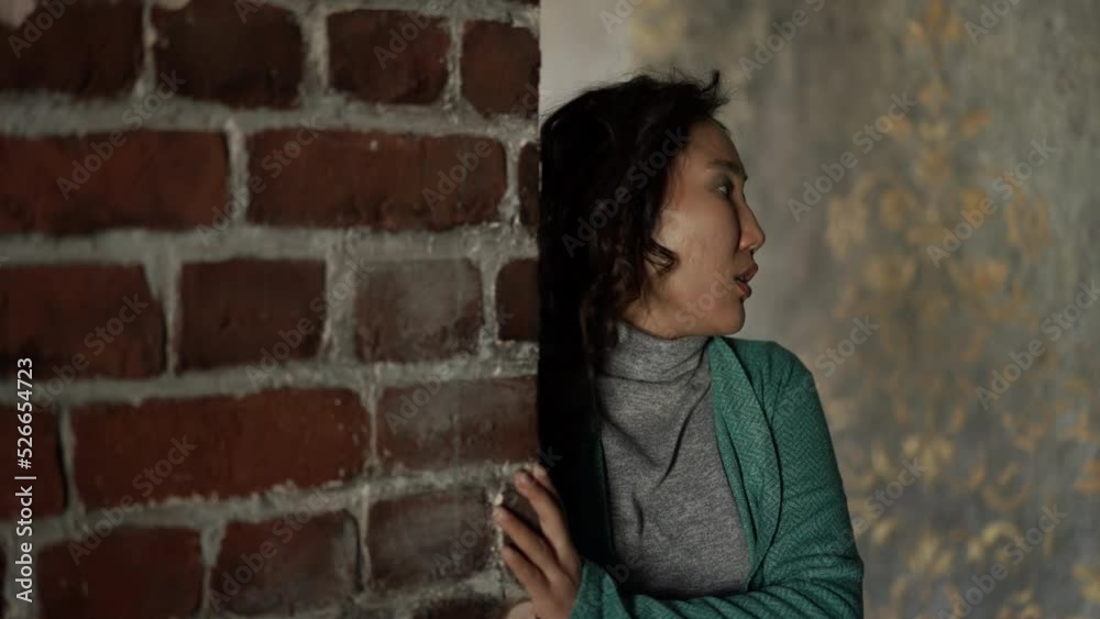 4k Young Asian woman is showing fear emotion for camera and hiding ...