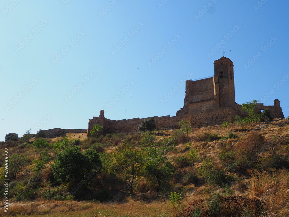 wall of the medieval castle of banabarre with two watchtowers, a large ...