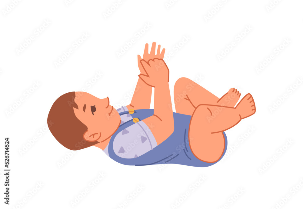 Small baby boy laying on its back and playing with hands and legs ...