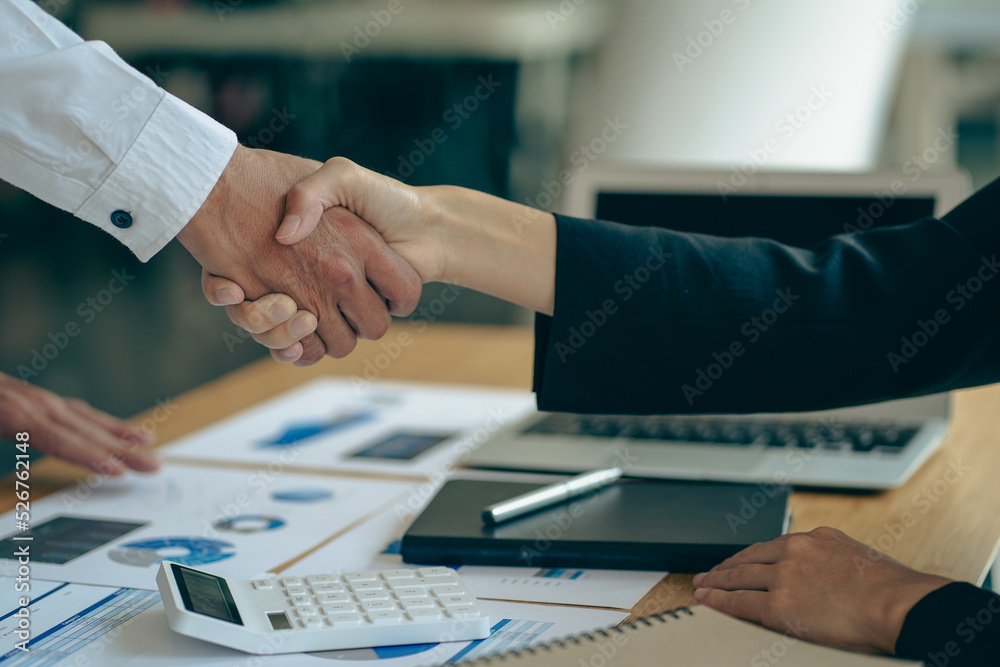 Young businessmen shake hands after a short job to sign a co-working ...