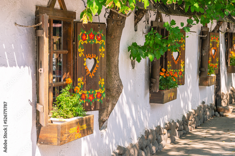 Ukrainian house with wooden painted shutters. The facade of the ...