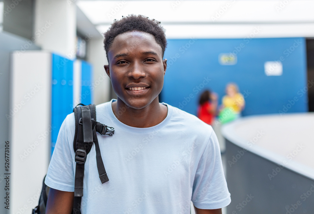 Portrait of young teenage african american student man standing at high ...