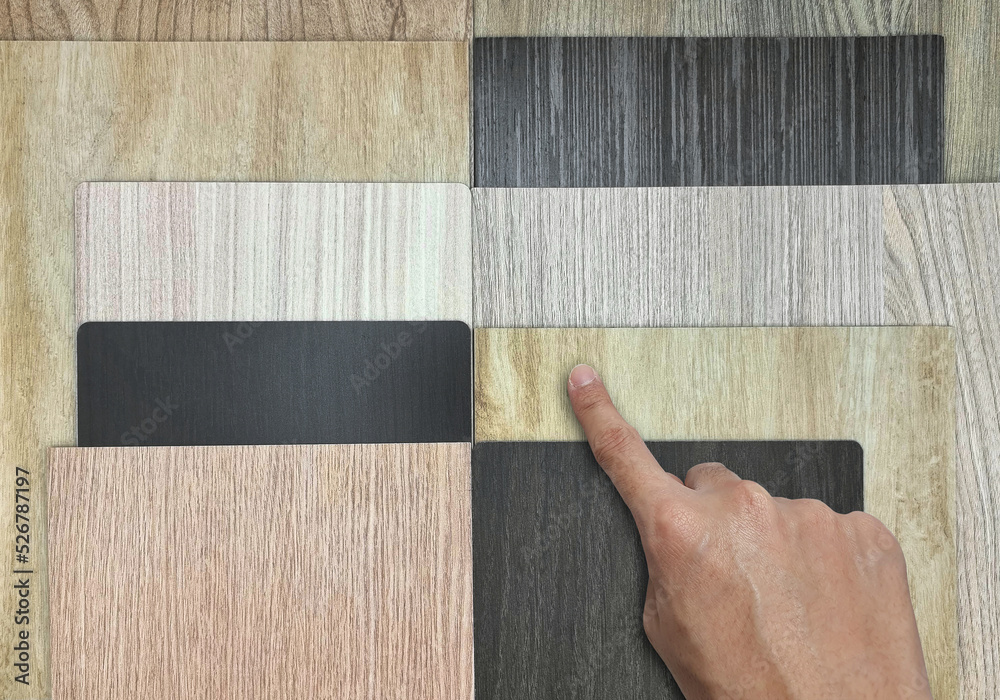 Designers Hand Selecting Various Types And Textures Of Interior Wooden Material Including