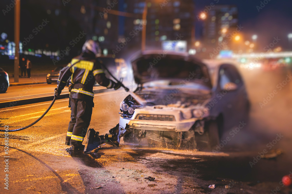 Group of fire men extinguishing and put out burning car crash after ...