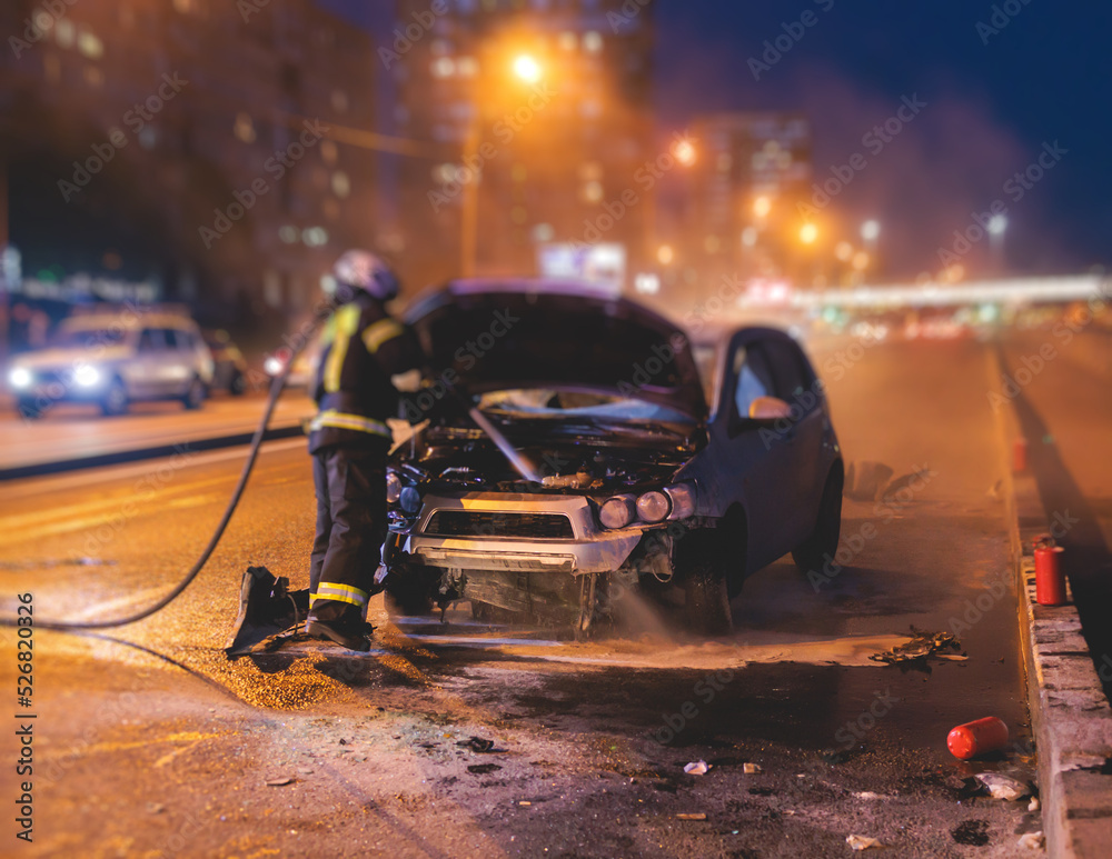 Group of fire men extinguishing and put out burning car crash after ...