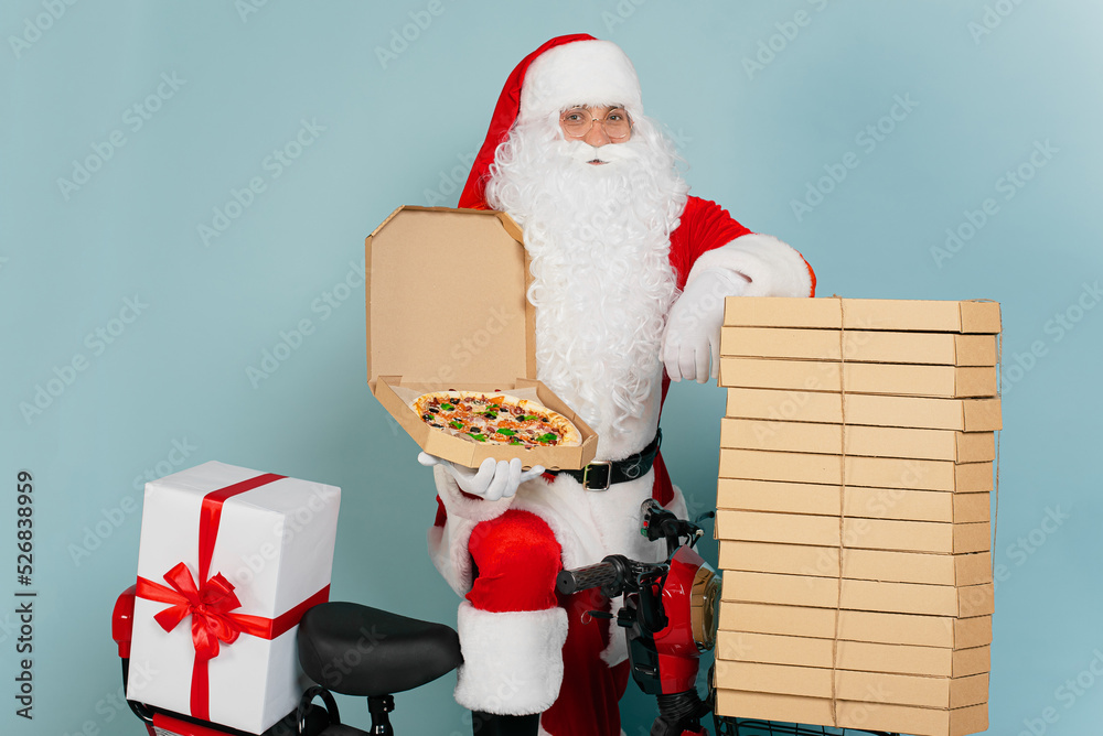 Pizza delivery man dressed as santa claus with an open pizza box in his ...