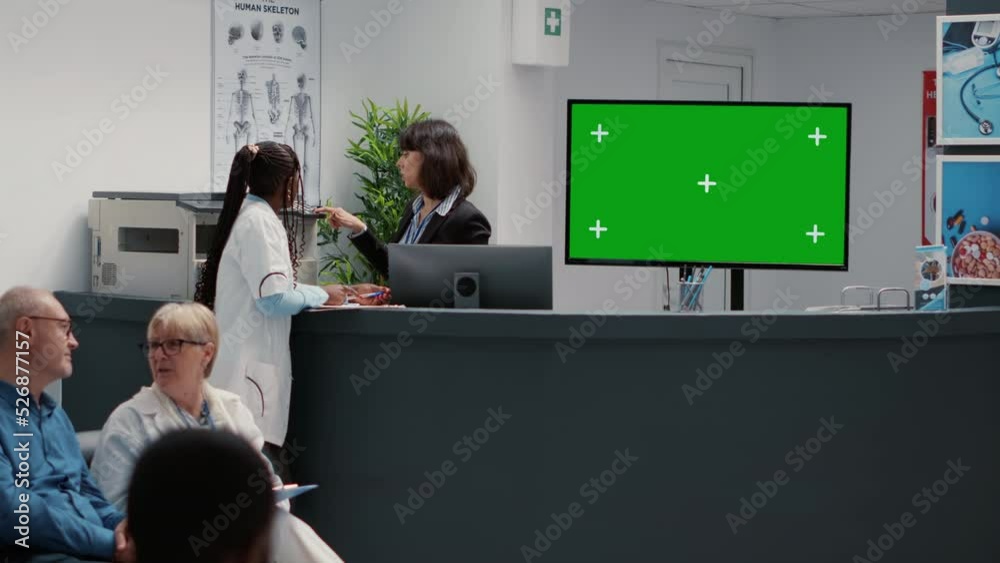 Monitor display with greenscreen background in hospital reception desk ...