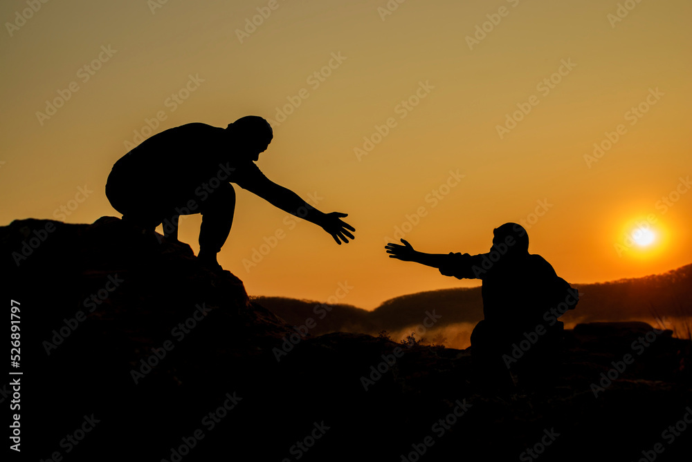 Silhouette of two people helping each other. Teamwork and Perseverance, Freedom and Success ...