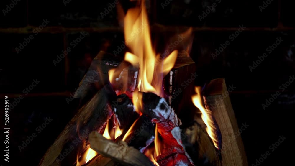In the darkness of the night, a fire is lit in nature. The fire slowly ...