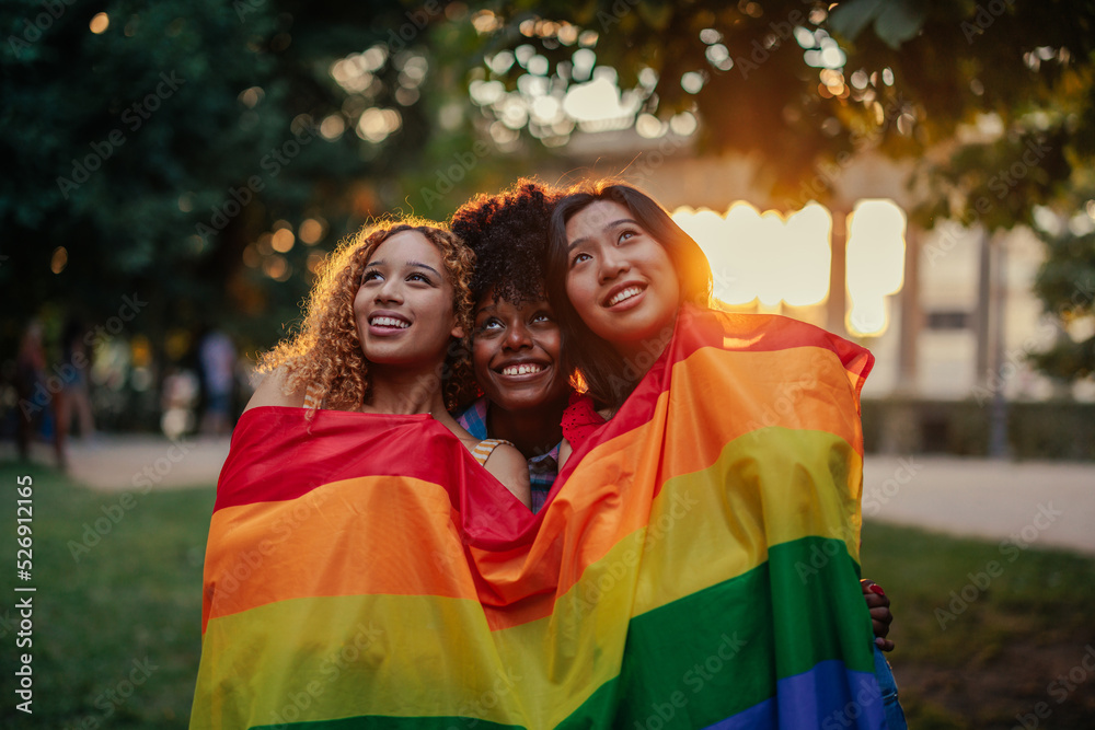 Transgender women with pride flag outdoors Stock Photo | Adobe Stock