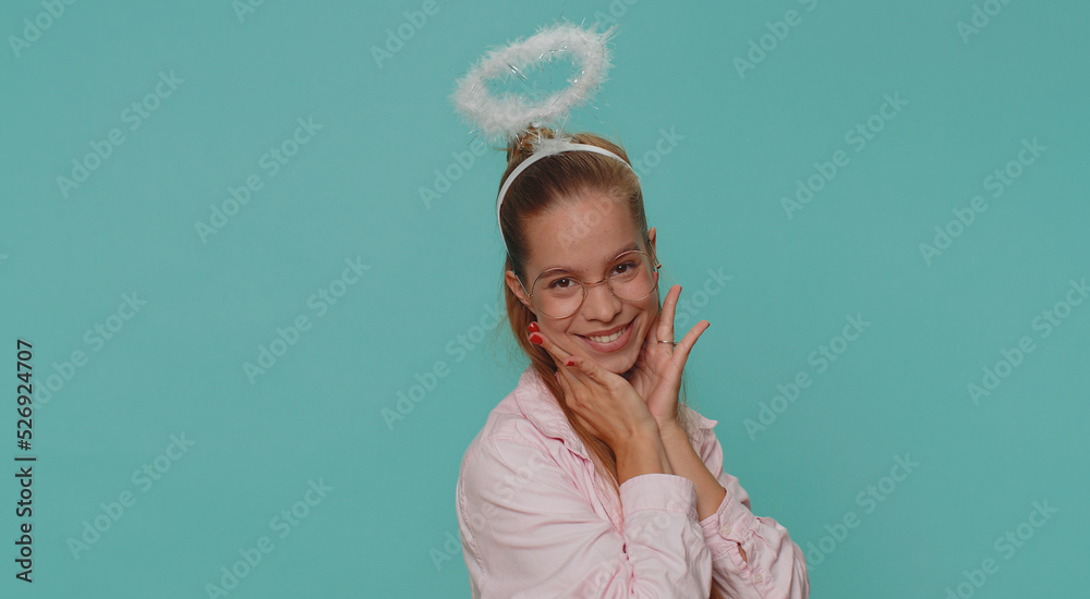 Portrait of smiling shy angelic pretty teenager young girl with angel ...