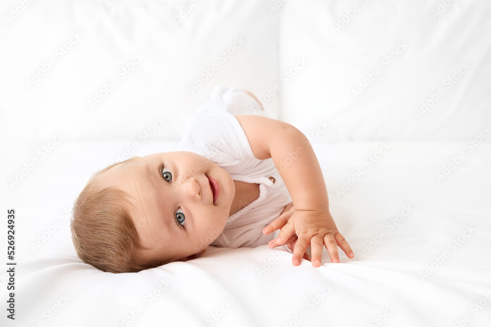 Beautiful baby girl lying on her side looking at camera Stock Photo ...