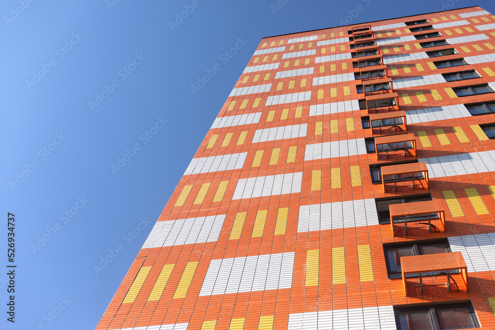 Orange building in modern style. House with identical windows. Lot of ...