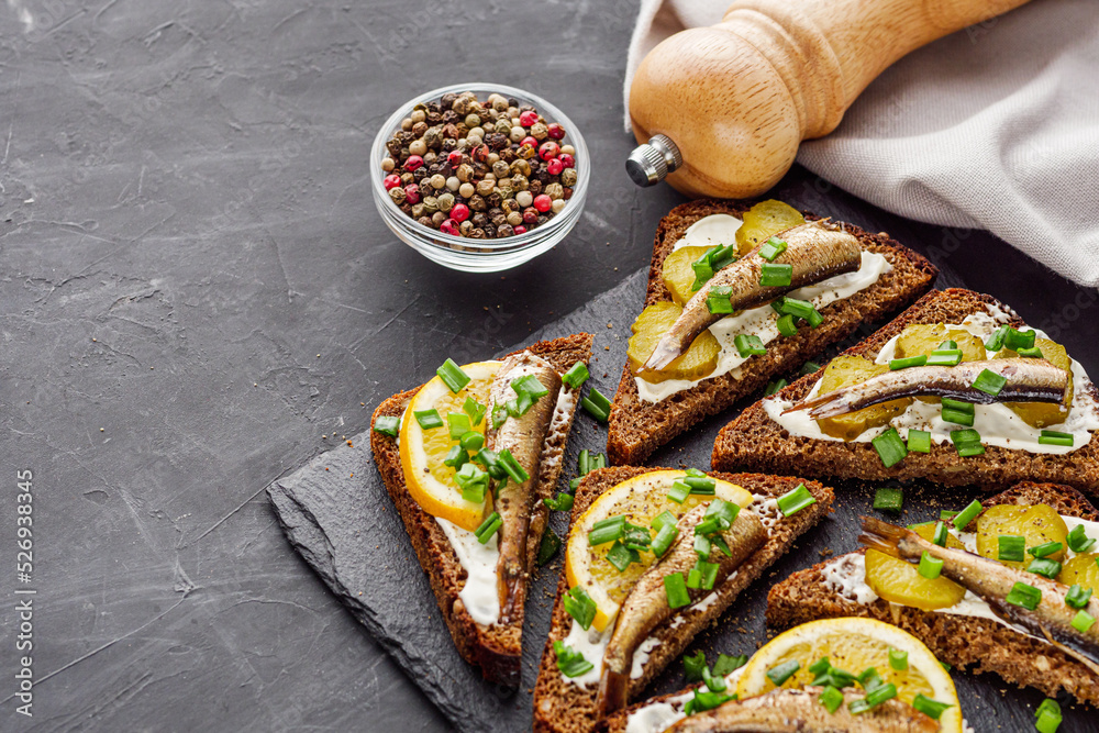 Poster canapes with sprats on a black stone tray – Wall Art | UkPosters