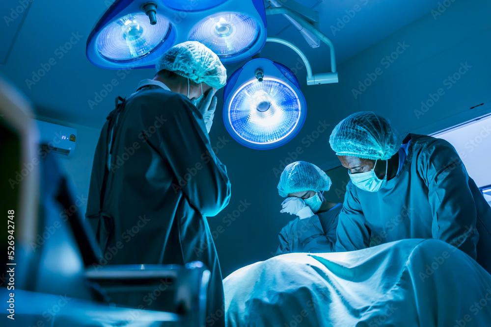 Team of surgeon doctors are crying and mourning over the patient's dead ...