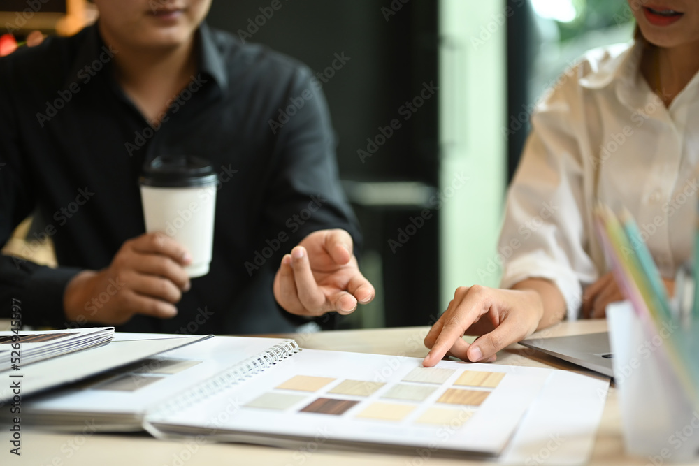 Two professional interior designers are working with color swatches and ...