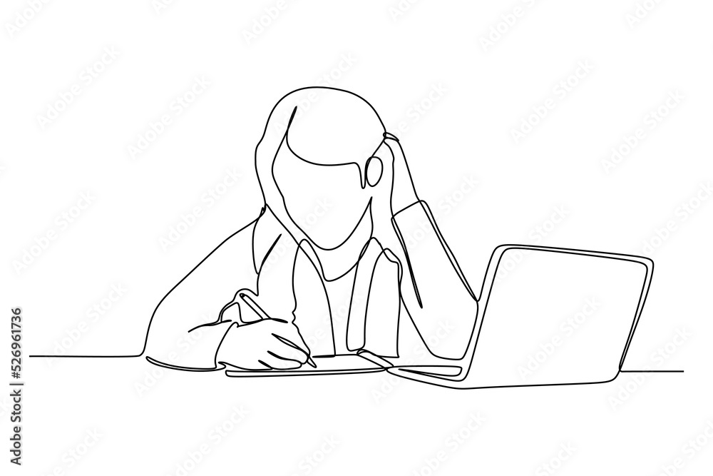 Young girl writing on the paper while studying in front of a not book ...