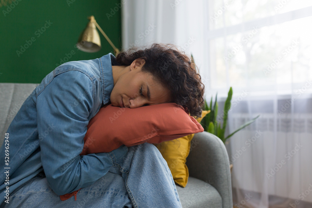 Beautiful woman sleeping at home on sofa hugging pillow, Hispanic woman ...