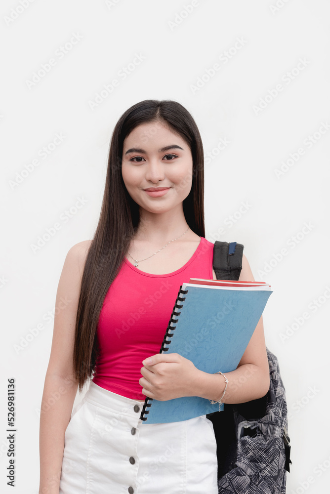 An attractive female senior high student carrying her books. Both ...