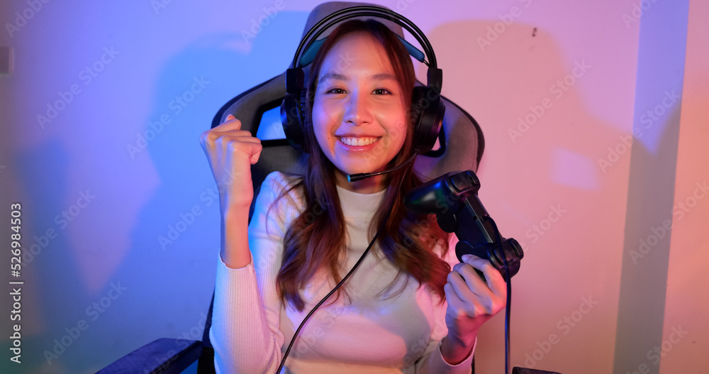 Winner gamer portrait, Young woman wearing headphones playing computer ...