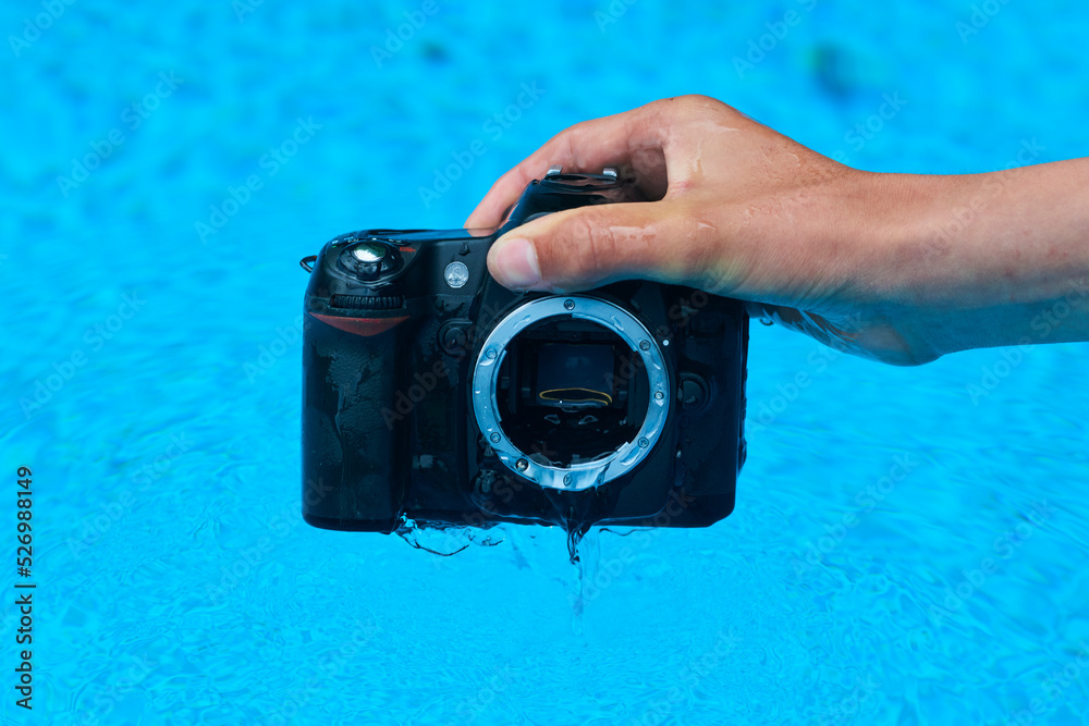 Washing dirty dslr camera in water. Crazy photographer poorly cleans ...