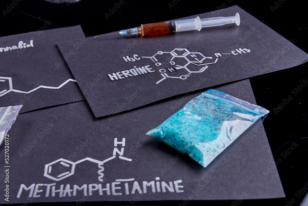 Sheets with heroine and methamphetamine drug molecules on black ...