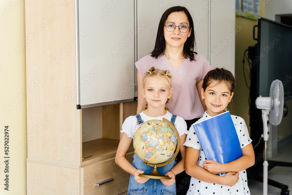 Education and school concept. Two student primary school girls with ...