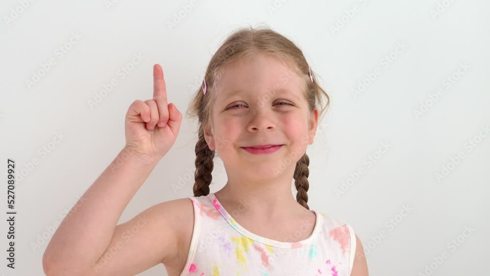 Portrait of smart beautiful little preschool girl. Raised index finger ...