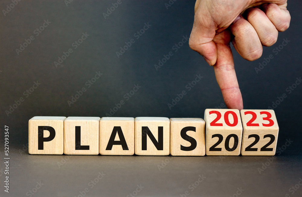 2023 plans new year symbol. Businessman turns a wooden cube and changes ...