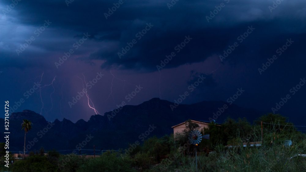 Lightning bolt and monsoon storm clouds over the Catalina Mountains in the Sonoran Desert north ...