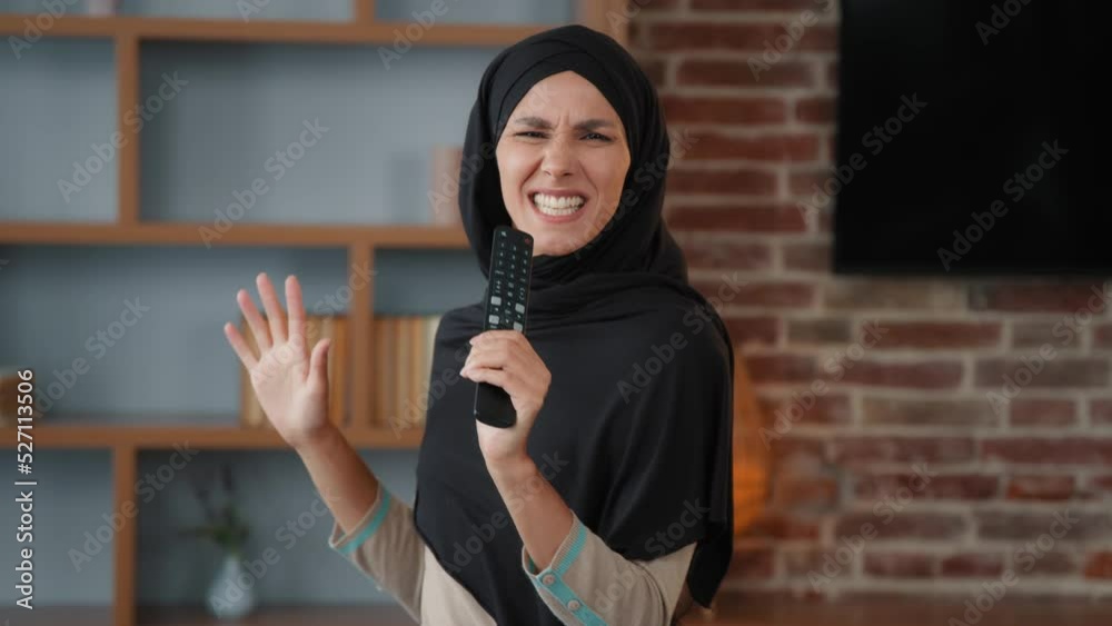 Arabian Muslim Islamic woman happy funny girl in hijab at home singing ...