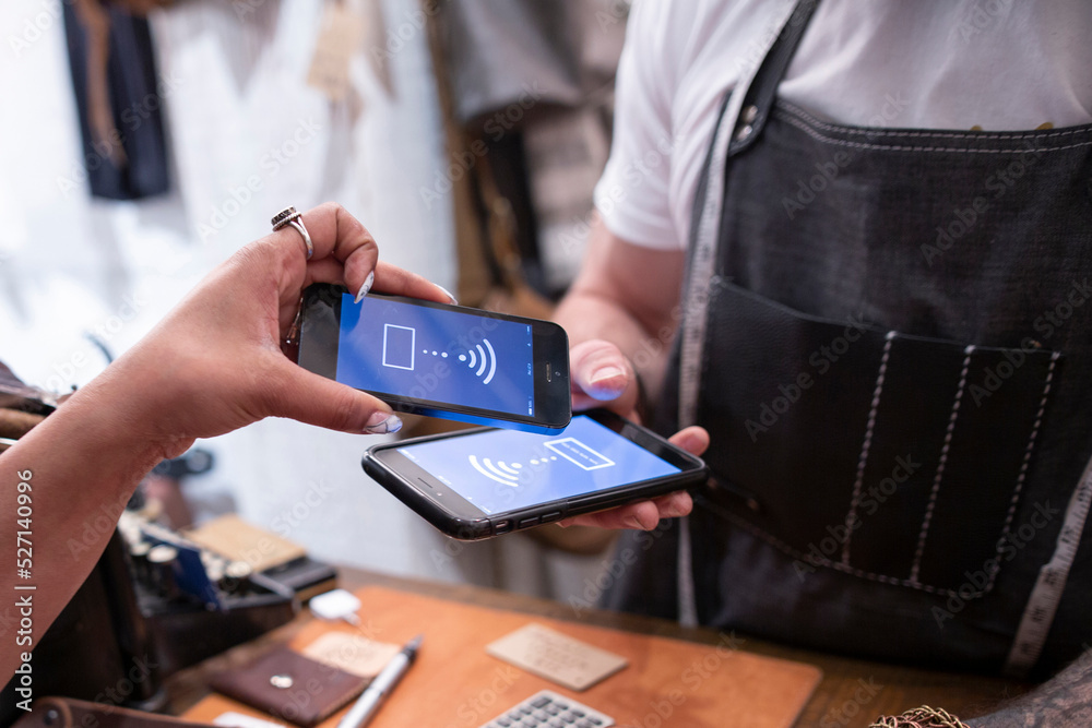 Customer using contactless payment in leather shop Stock Photo | Adobe ...