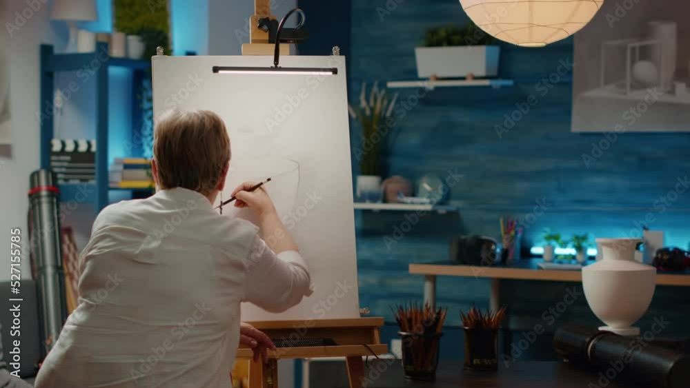Retired woman drawing outline sketch of vase model, creating ...