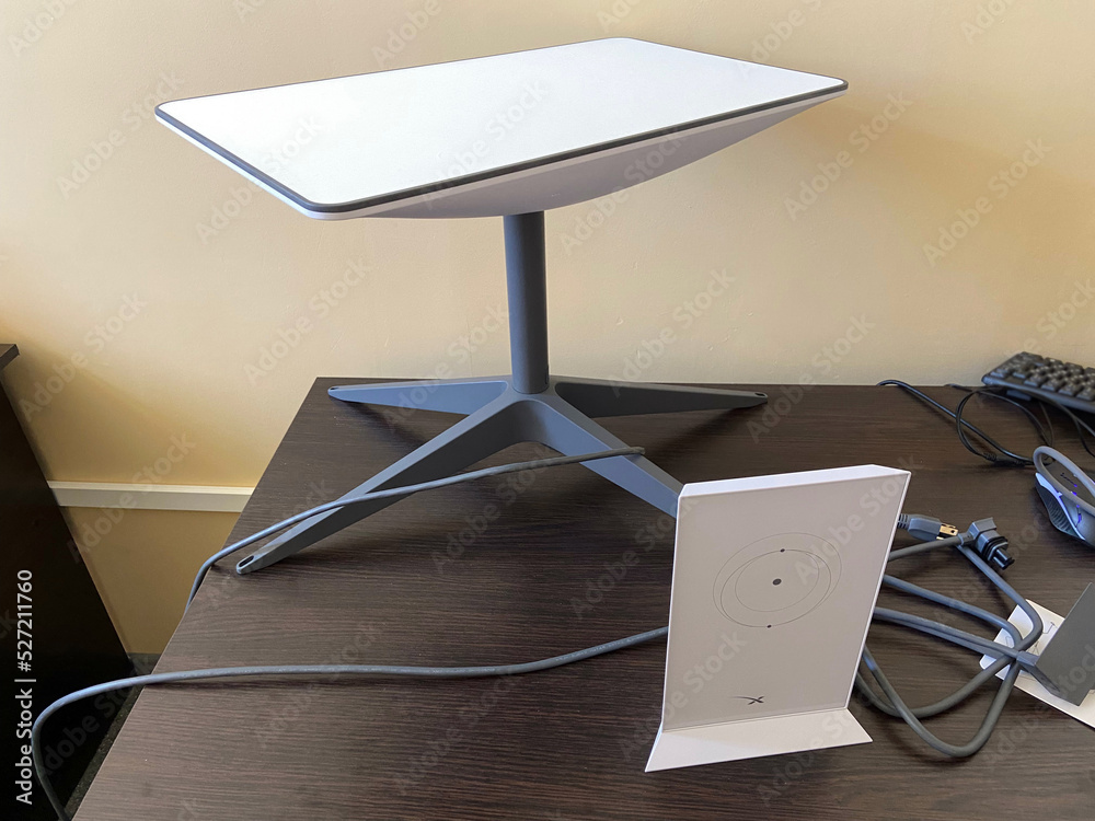 Starlink space signal receiver in the table in office. Starlink is a ...