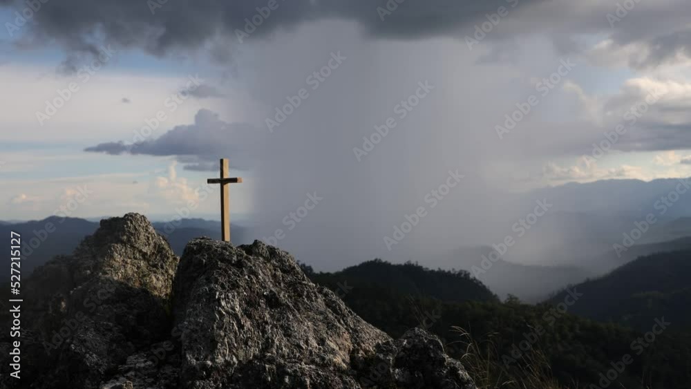 Christian cross on top rock mountain on the colorful sky background ...
