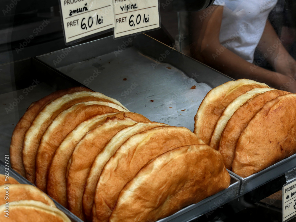 Romanian doughnuts called gogosi on a stall. The price is indicated on ...