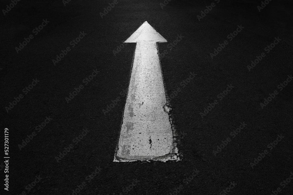 Straight ahead direction arrow road sign painted on bitumen asphalt ...