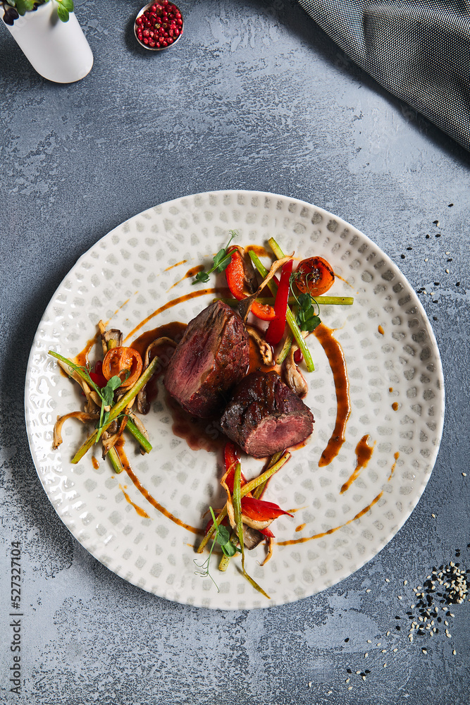 Roasted Beef fillet with vegetables. Roasted Mignon steak with paprika ...