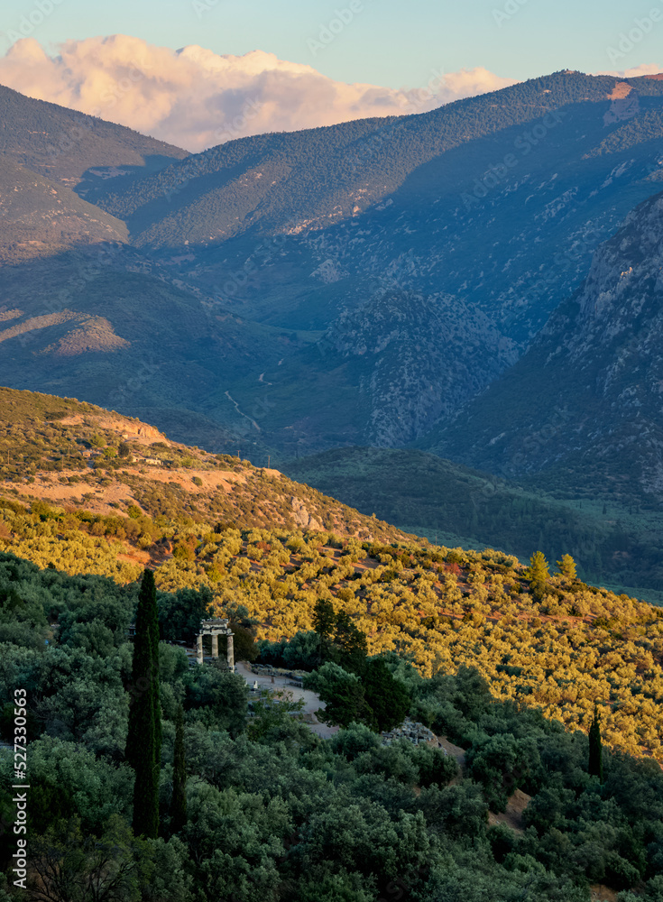 View towards the Tholos of Delphi, Temple of Athena Pronaia, sunset ...