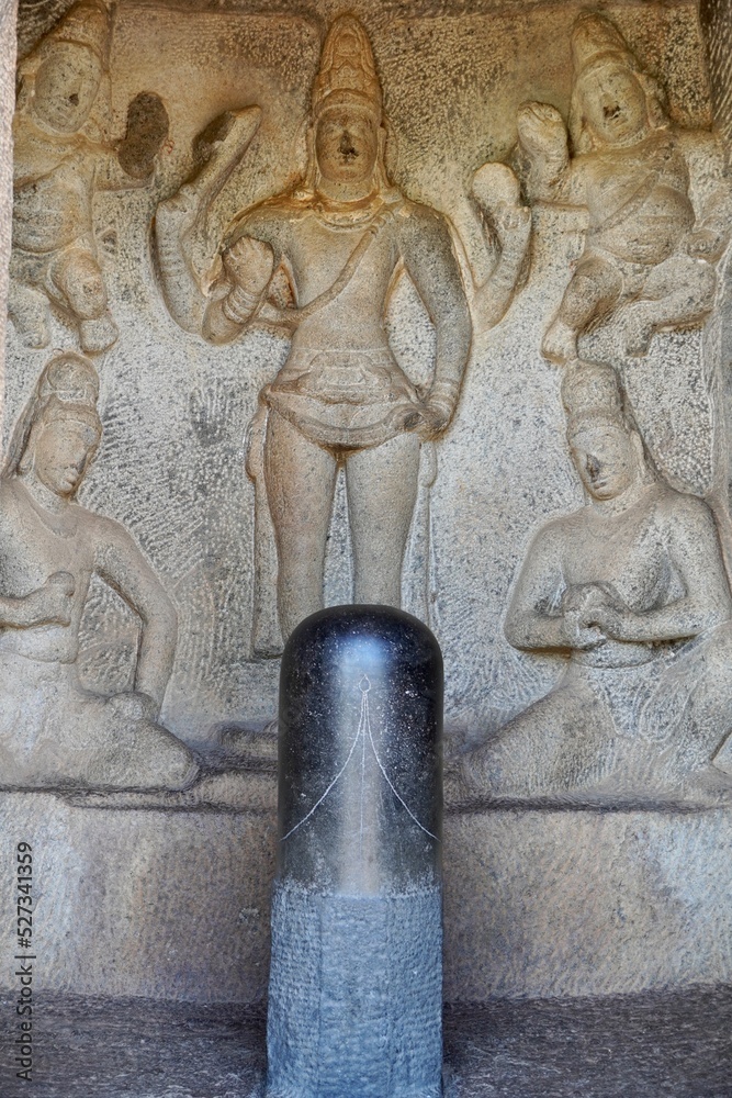 Black Shiva Lingam inside the temple with bas relief God sculptures in ...