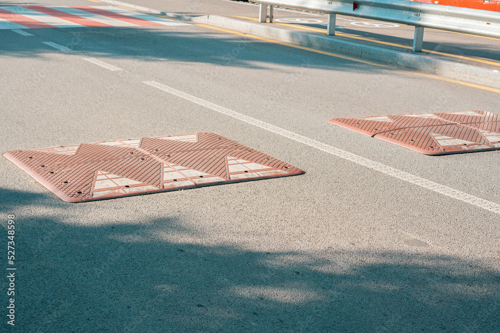 Brown rectangular speed bumps installed on the road. Nobody. Roadblock ...
