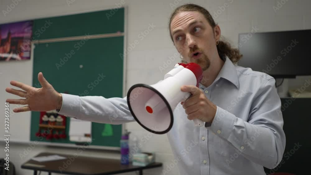 Angry teacher shouting in classroom into megaphone loudhailer, bullhorn ...
