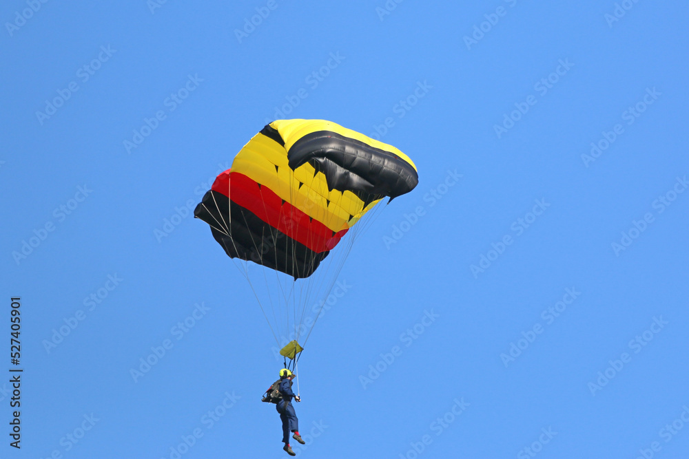 Skydiver flying wing in a blue sky Stock Photo | Adobe Stock