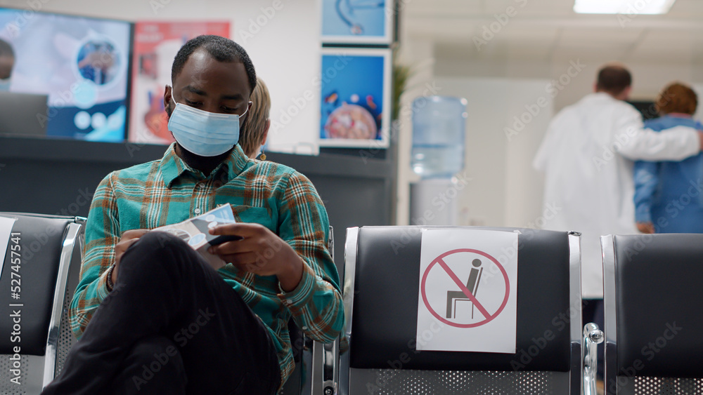 Diverse patients sitting in waiting room lobby to attend checkup visit ...