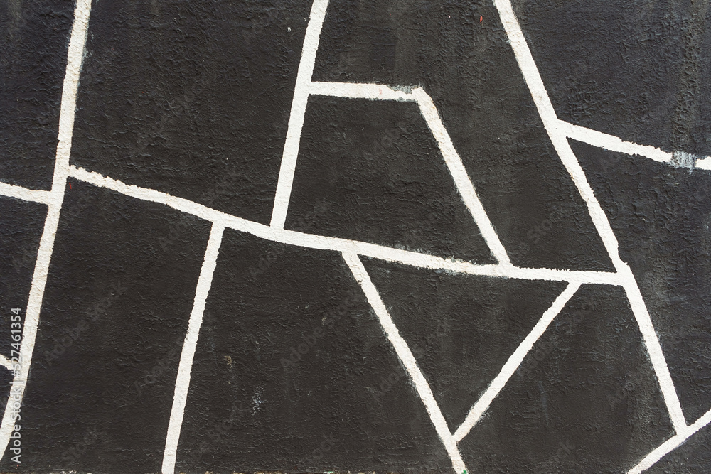 straight white lines on a black wall. geometrically straight lines on ...
